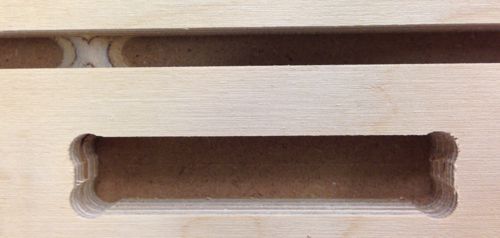 Dog bone shaped hole used to hold table top. In the upper left corner ...